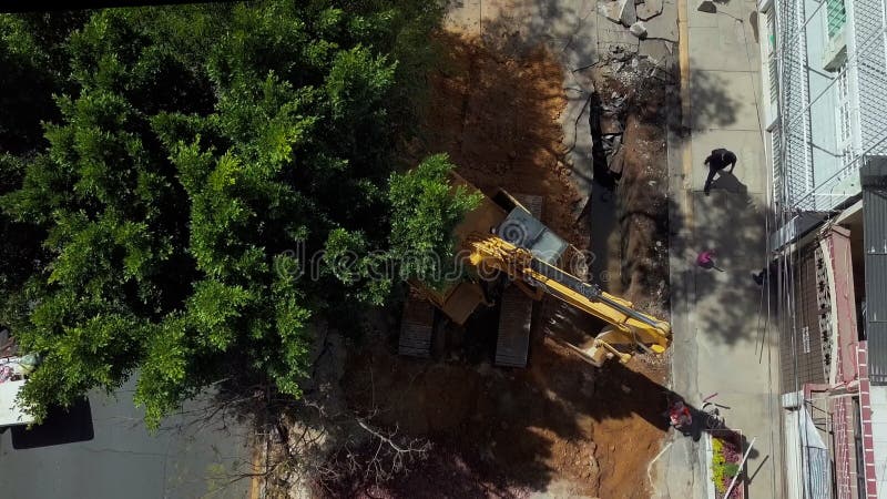 Aerial View of an Excavator Digging on Construction Site Under a Tree ...