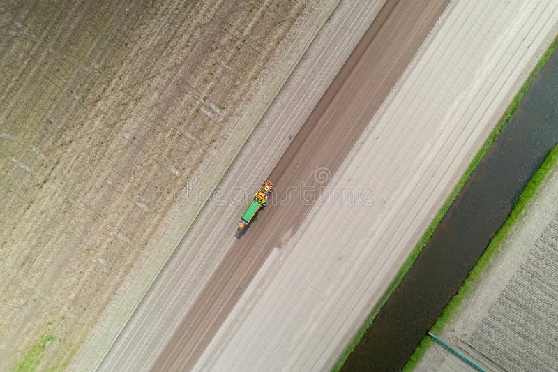 Aerial View of Farm Equipment Seeding in the Empty Agriculture Fields ...