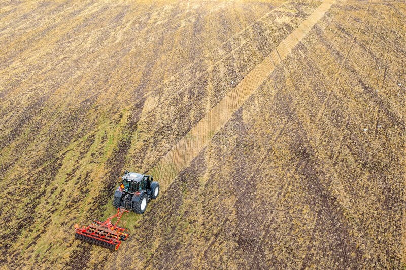 Aerial View of a Farm Field with a Tractor Cutting the Grass Stock ...