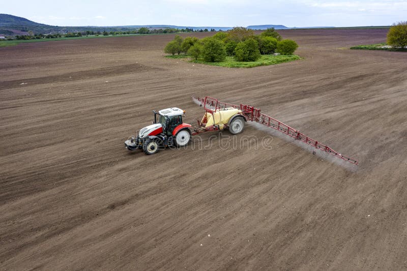 Tractor Spraying Grain on Field Stock Image - Image of machine, nature ...