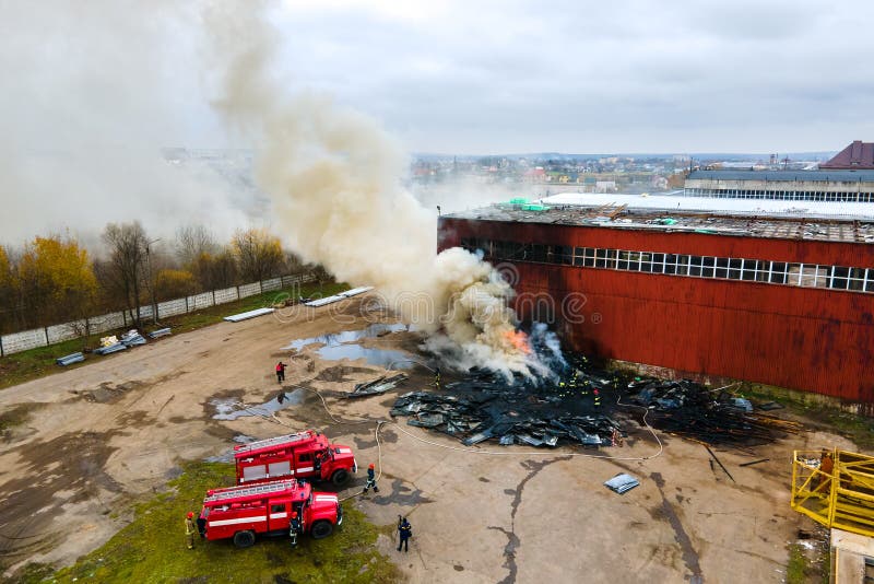 Aerial View of Firefighters Extinguishing Fire in Industrial Area Stock ...
