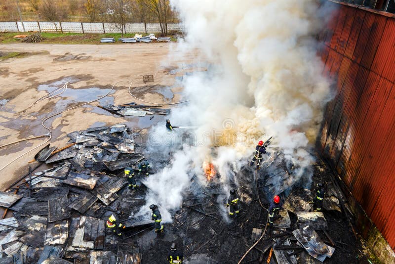 Aerial View of Firefighters Extinguishing Fire in Industrial Area Stock ...