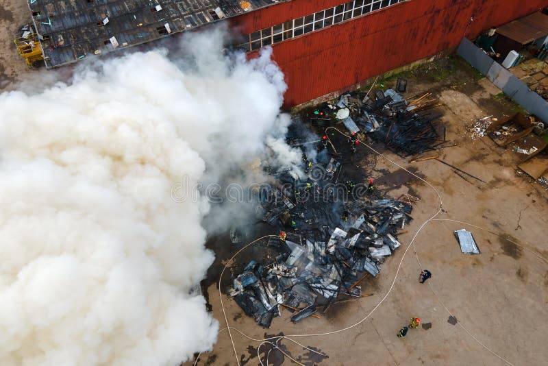 Aerial View of Firefighters Extinguishing Fire in Industrial Area Stock ...