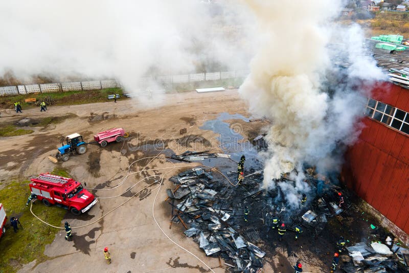 Aerial View of Firefighters Extinguishing Fire in Industrial Area Stock ...