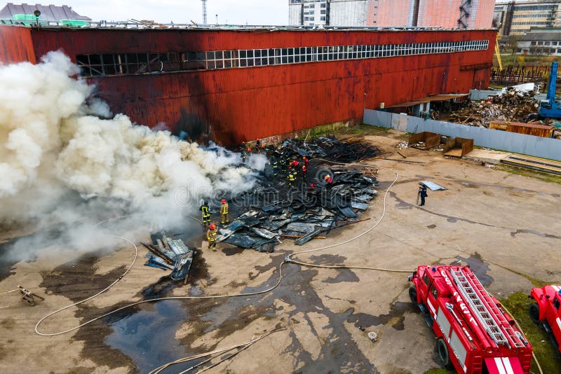 Aerial View of Firefighters Extinguishing Fire in Industrial Area ...