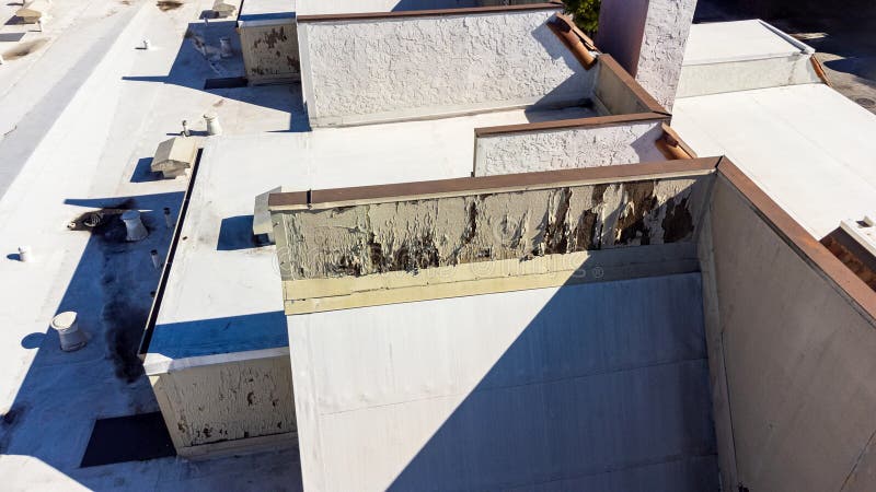 Aerial View of a Flat Rooftop with Peeling Walls, Weather Damage, and ...
