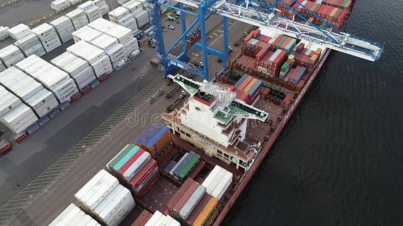 A Crane Loading Scrap in Cargo Ship Vessel at Recycling Metal Plant ...
