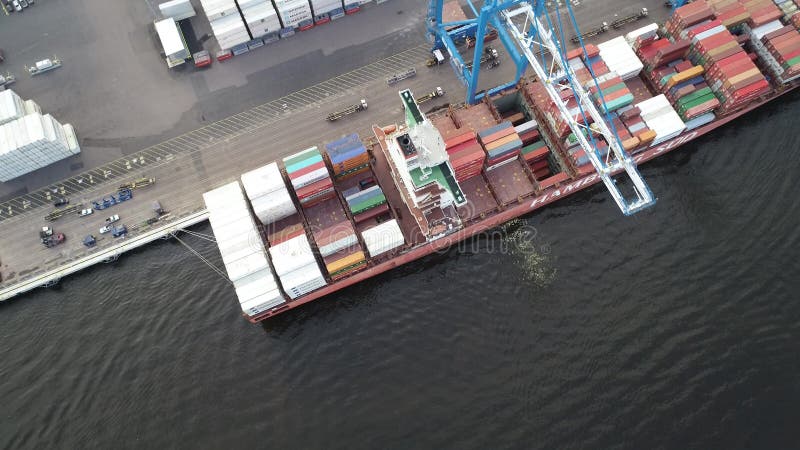 A Crane Loading Scrap in Cargo Ship Vessel at Recycling Metal Plant ...