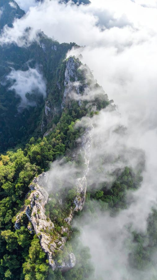 Aerial View of Green Mountains with White Mist and Clouds Daytime ...