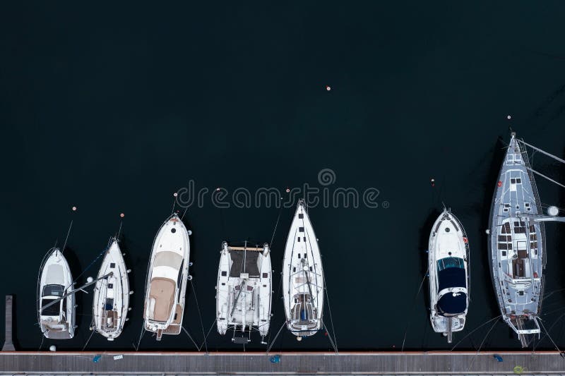 An Aerial View Shows Many Boats Docked in the Harbor at a Dock Stock ...