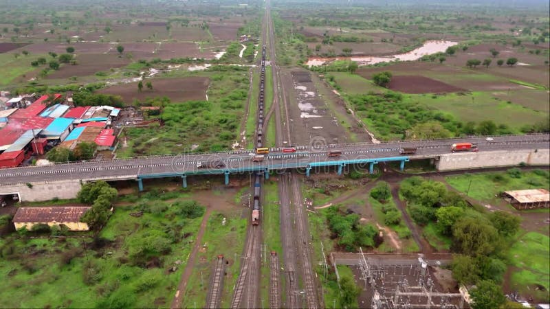 Aerial View of Highway with Cargo Train Going Under Bridge Stock Video ...