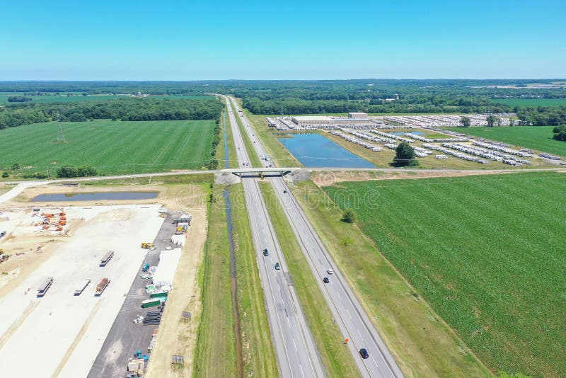 Aerial View of a Highway Road through a Green Field with a Pond Stock ...