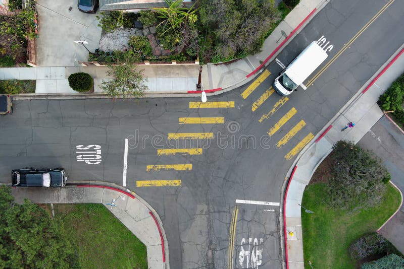 Aerial View of an Intersection Surrounded by Greenery in the Daylight ...