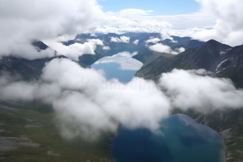 Aerial View of Lake Surrounded by Mountains, with Clouds Floating ...