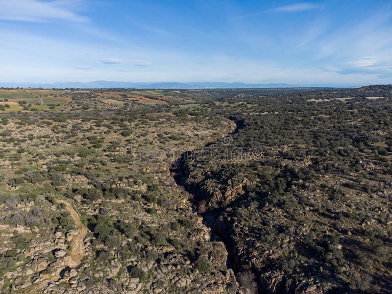 Aerial View of a Landscape with Greenery and a Narrow Pathway in Span ...