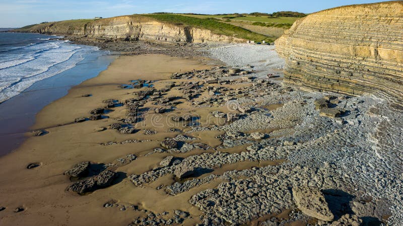 Aerial View of Large Limestone Cliffs and a Sandy Beach Next To the Sea ...