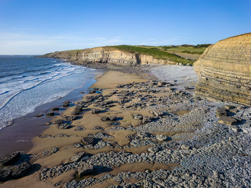 Aerial View of Large Limestone Cliffs and a Sandy Beach Next To the Sea ...