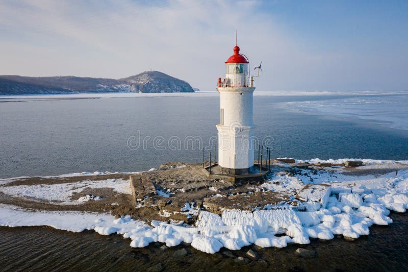 Aerial View of the Lighthouse in Winter in the Ice at Dawn Stock Photo ...