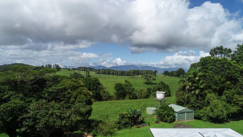 Aerial View of Lush Green Fields with a Mountain Backdrop Stock Photo ...