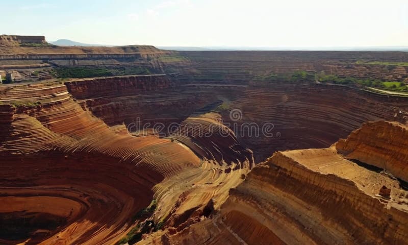 An Aerial View of a Massive Terraced Open-pit Mine with Layered Rock ...