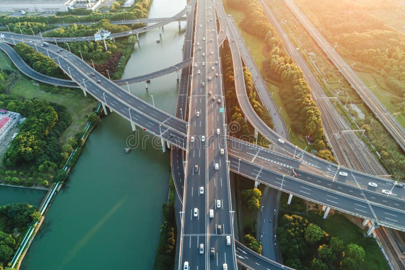 Aerial View of Multiple Highways Intersect Above a Calm River ...