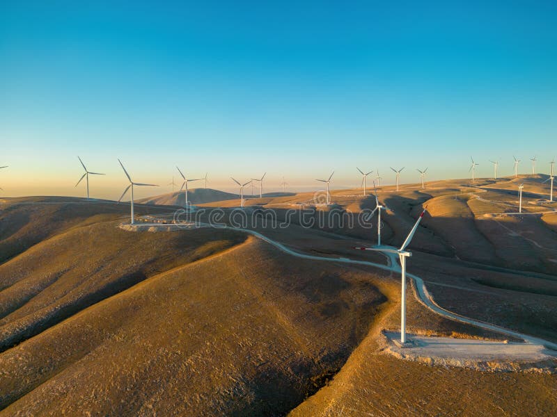 Aerial View of Multiple Wind Turbines Standing on a Hill and Generating ...