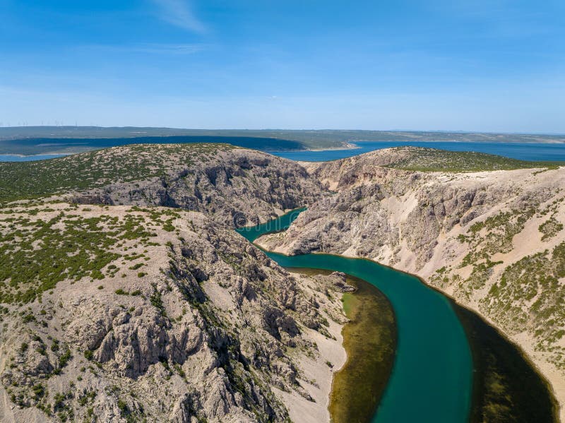 Aerial View of a Narrow River Passing through Giant Cliffs on a Sunny ...