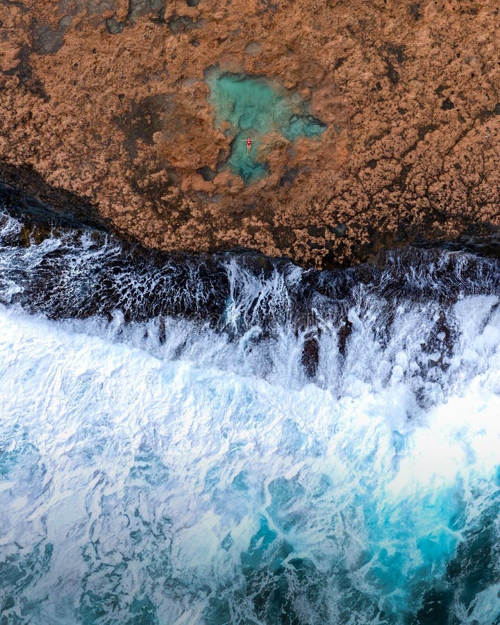 Aerial View of a Natural Pool on a Rocky Shoreline with Crashing Ocean ... Aerial View of a Natural Pool on a Rocky Shoreline with Crashing Ocean ...