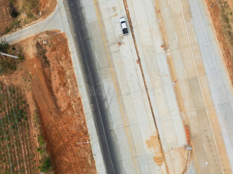 Aerial View of New Road Construction with Vehicles on Partially ...