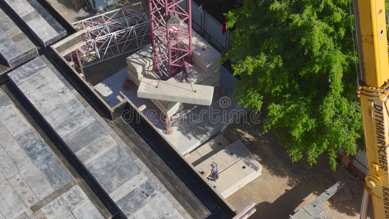 Aerial View: Operators Lift and Position a Crane on-site with Engineers ...