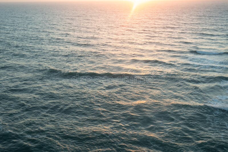 Aerial View Over the Ocean and Sun Rising Over Water Waves Surface ...