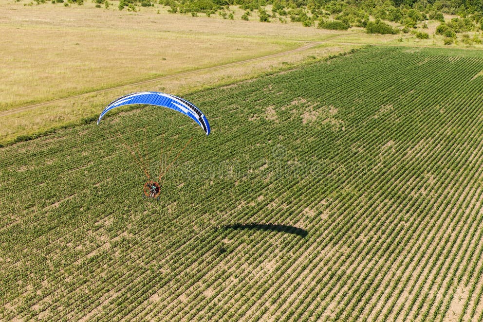 Aerial View of Paramotor Flying Over the Fields Stock Image - Image of ...