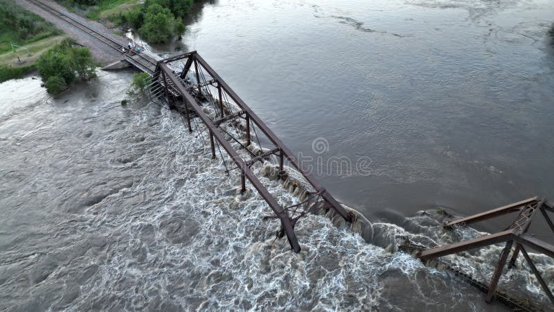 Aerial View of a Partially Collapsed Railway Bridge Over a River with ...