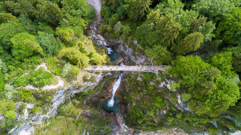 Aerial View of a Pedestrian Bridge through a Gorge with a Waterfall ...