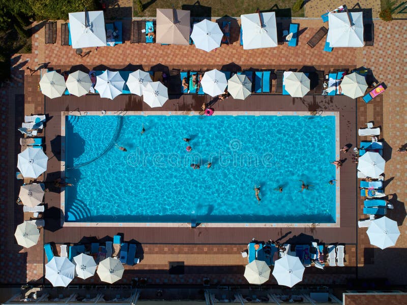 Aerial View on People in Swimming Pool. Top View of People Sunbathing ...