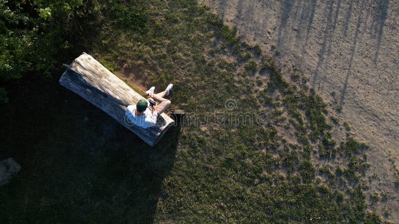 Aerial View of a Person Sitting on a Thick Log Stock Image - Image of ...