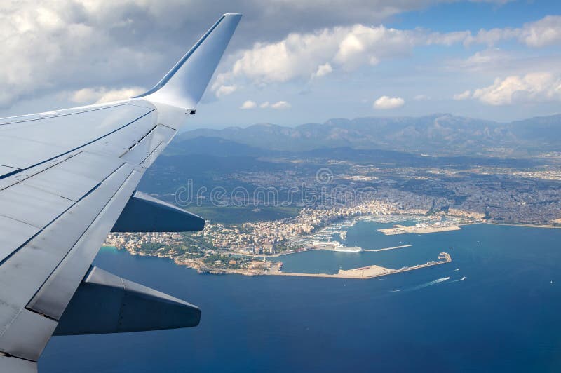 View of Land from Aircraft, Blue Sea, Above the Clouds Stock Photo ...
