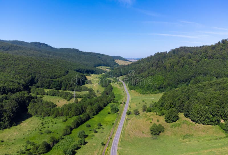 Aerial View of a Road through the Green Forested Hillside Stock Image ...