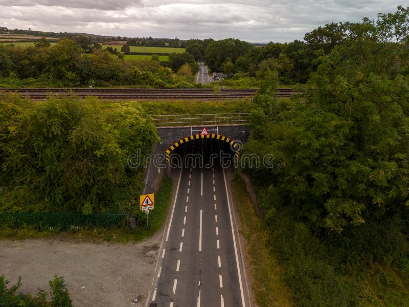 Aerial View of a Road Passing Under a Railway Bridge in the British ...