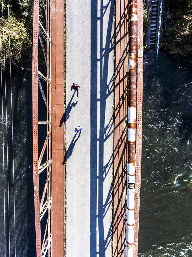 Aerial View of a Runner Running Across Bridge Over the River. Morning ...