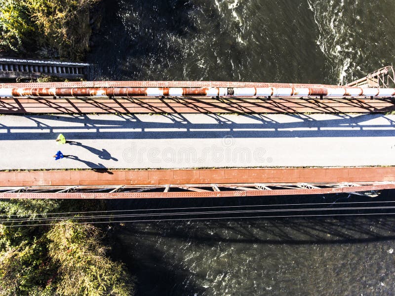 Aerial View of a Runner Running Across Bridge Over the River. Morning ...