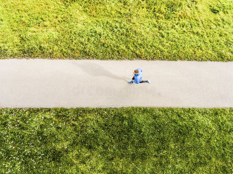 Aerial View of a Runner Running through Autumn Park on Jogging Path ...
