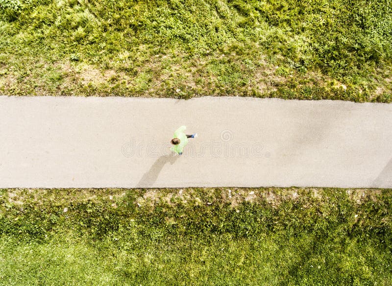 Aerial View of a Runner Running through Autumn Park on Jogging Path ...