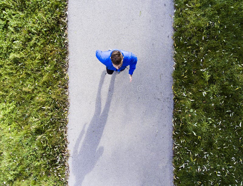 Aerial View of a Runner Running through the Park on a Jogging Path ...