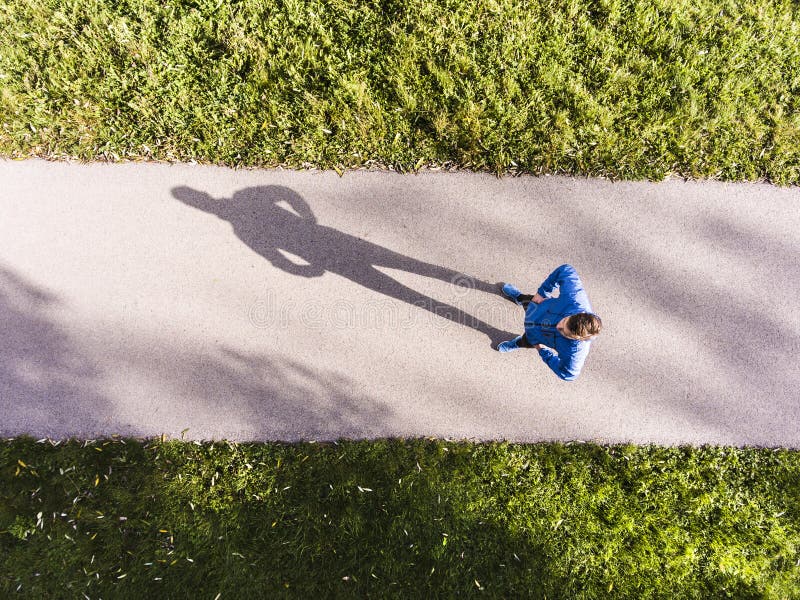 Aerial View of a Runner Running through the Park on a Jogging Path ...