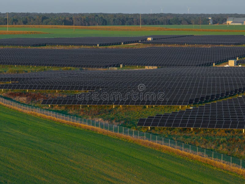 Aerial View of Solar Panel Field with Wind Turbines in Lithuania Stock ...