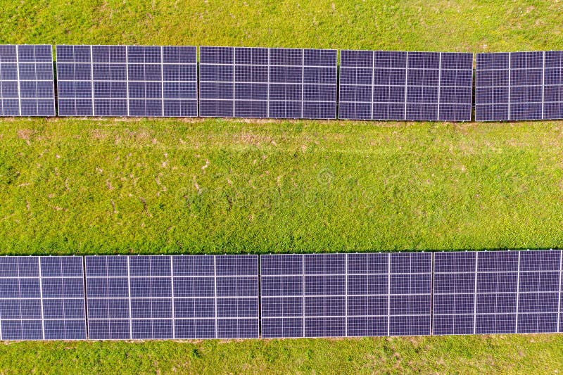 Aerial View of Solar Panels in a Field of Green Grass Stock Image ...