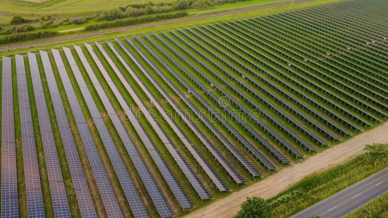 Aerial View of Solar Panels with Railway Tracks in Background Stock ...