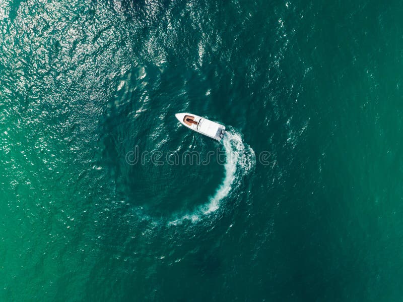 Aerial View of Speed Boat in the Aqua Sea Making a Circle, Drone View ...