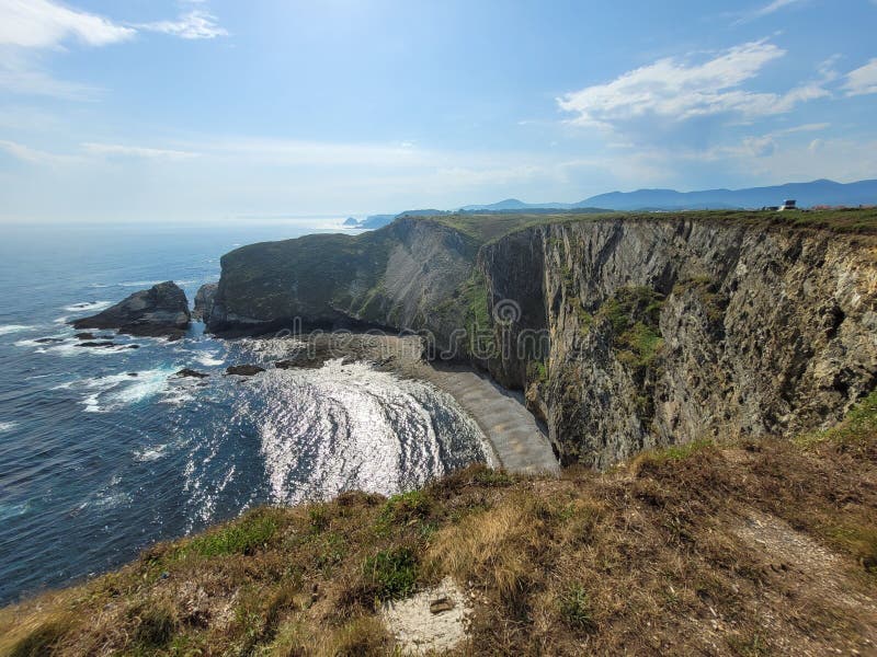 Aerial View of Steep Rock Formations Overlooking the Sea Under Blue ...